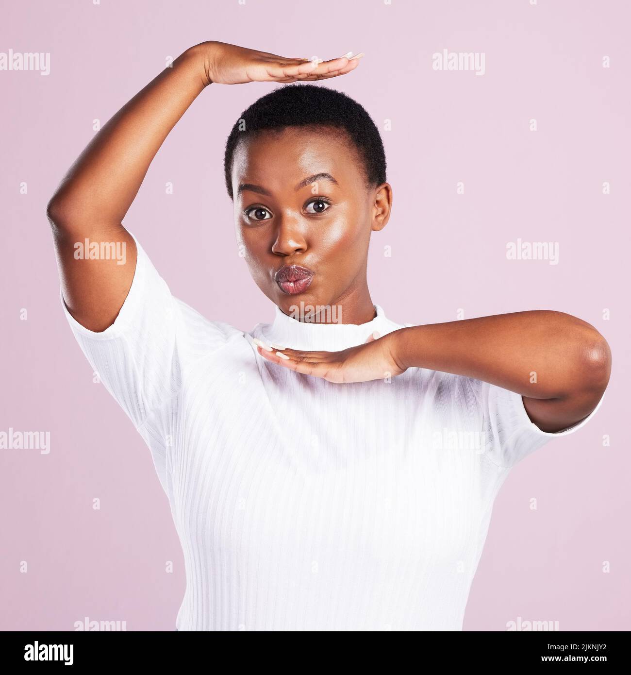Picture perfect. Studio portrait of a young woman holding up her hands ...