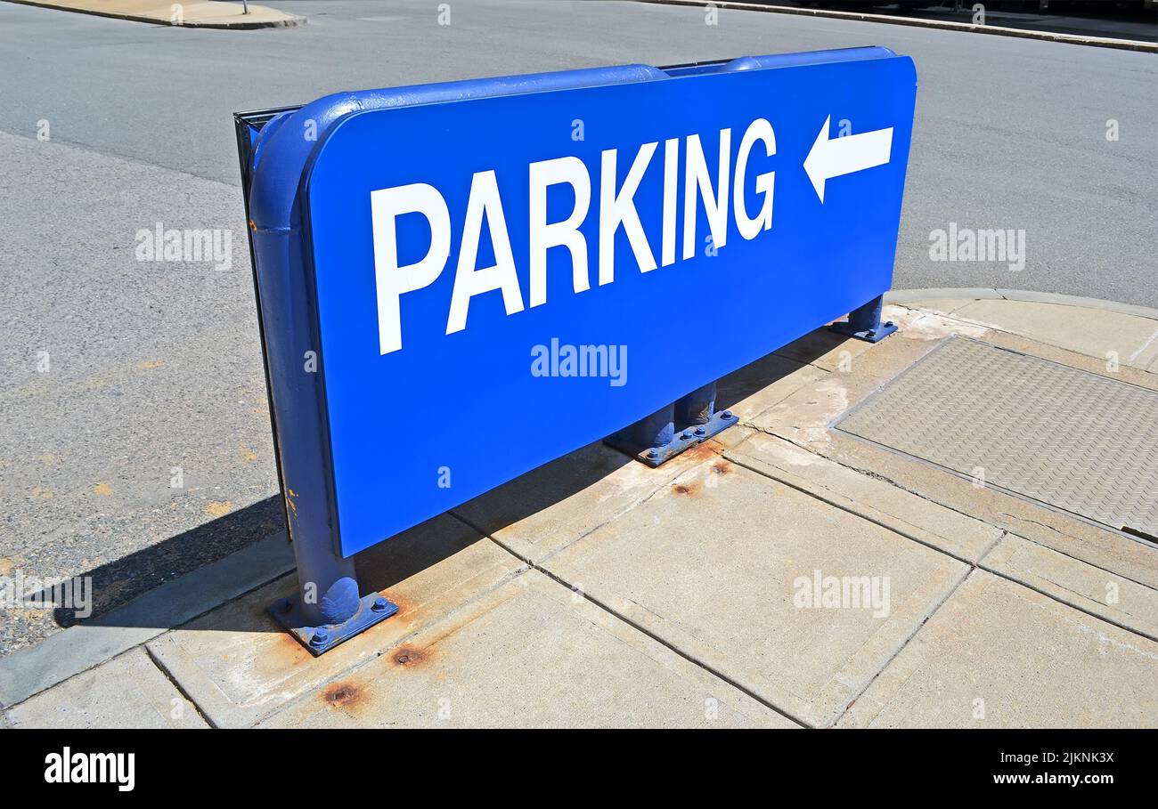blue parking sign closeup with arrow on asphalt, modern transportation ...