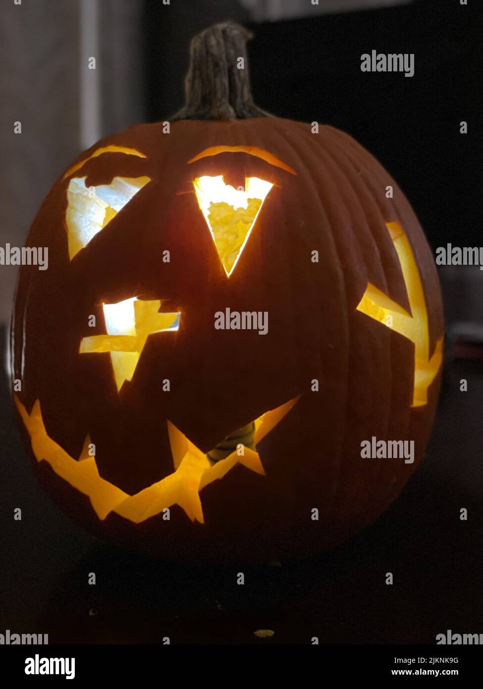 A vertical shot of a carved pumpkin for Halloween Stock Photo - Alamy