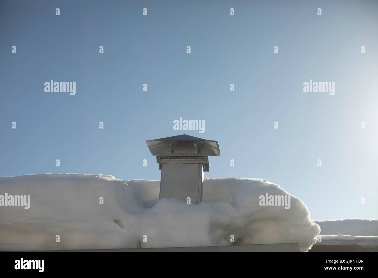 Chimney on roof in winter without smoke. Snow on roof. Details of house ...