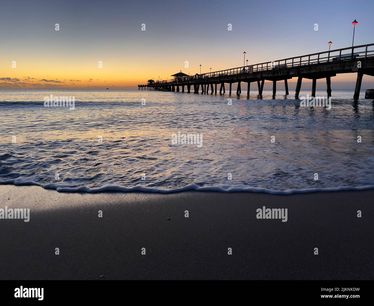 Sunrise on the Atlantic Ocean east coast of Florida with a fishing pier ...