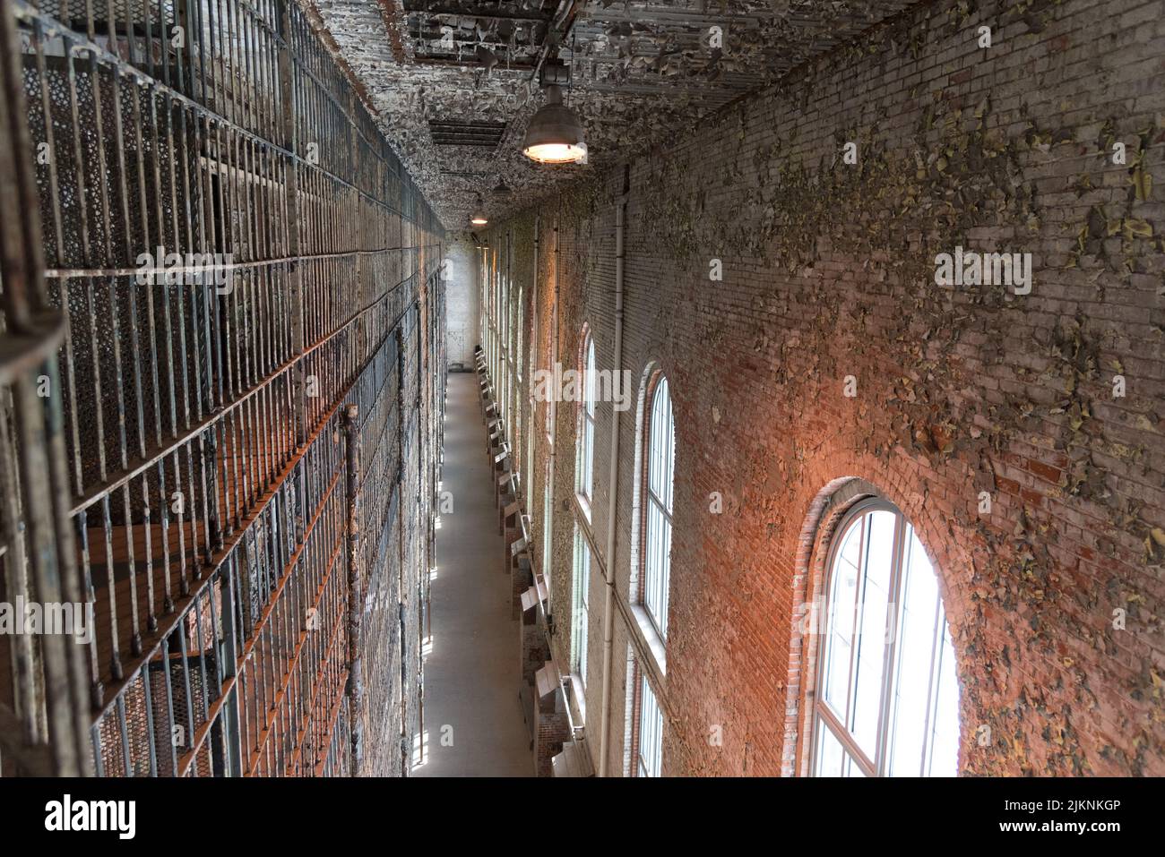 A long corridor in a wethered prison with rusty walls Stock Photo - Alamy