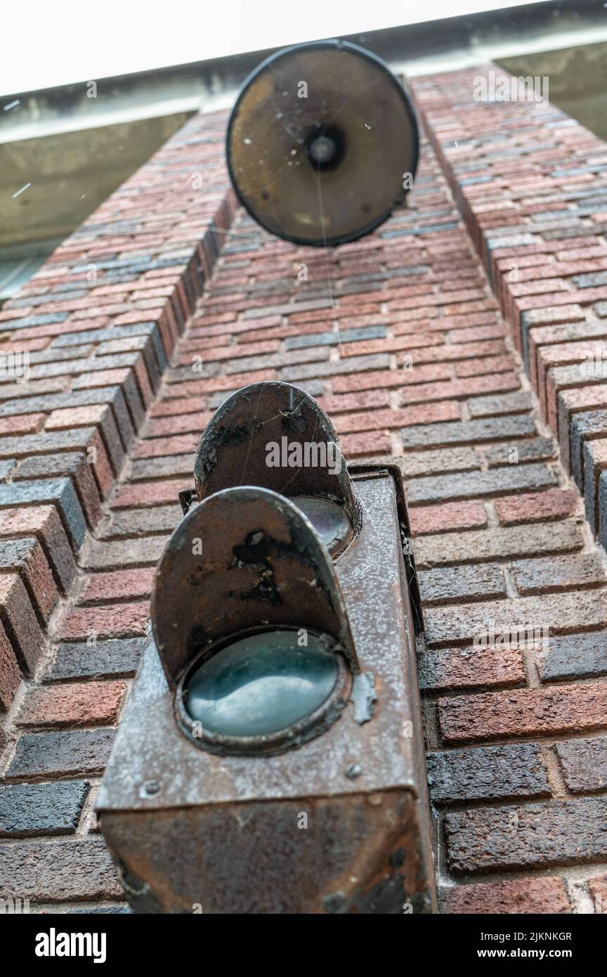 A vertical shot of a brick wall with a loading dock light signal Stock ...