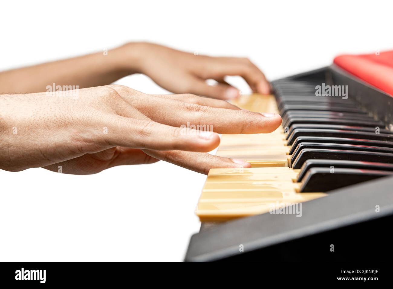 Closeup view of human hand playing electronic piano keyboard isolated ...