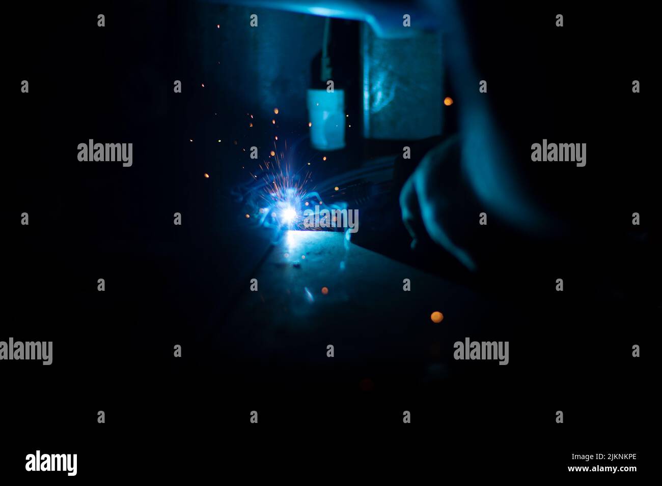 Steel welding. Metal processing. Welder makes welding seam. Details of ...