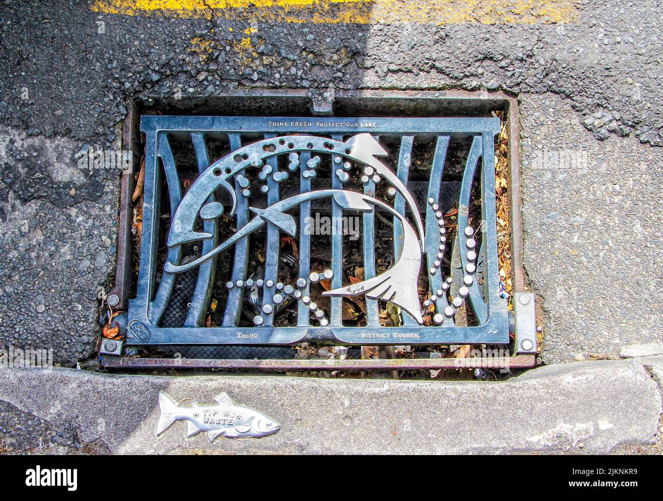A top view of road drain cover with trout fish sign in Taupo Stock ...