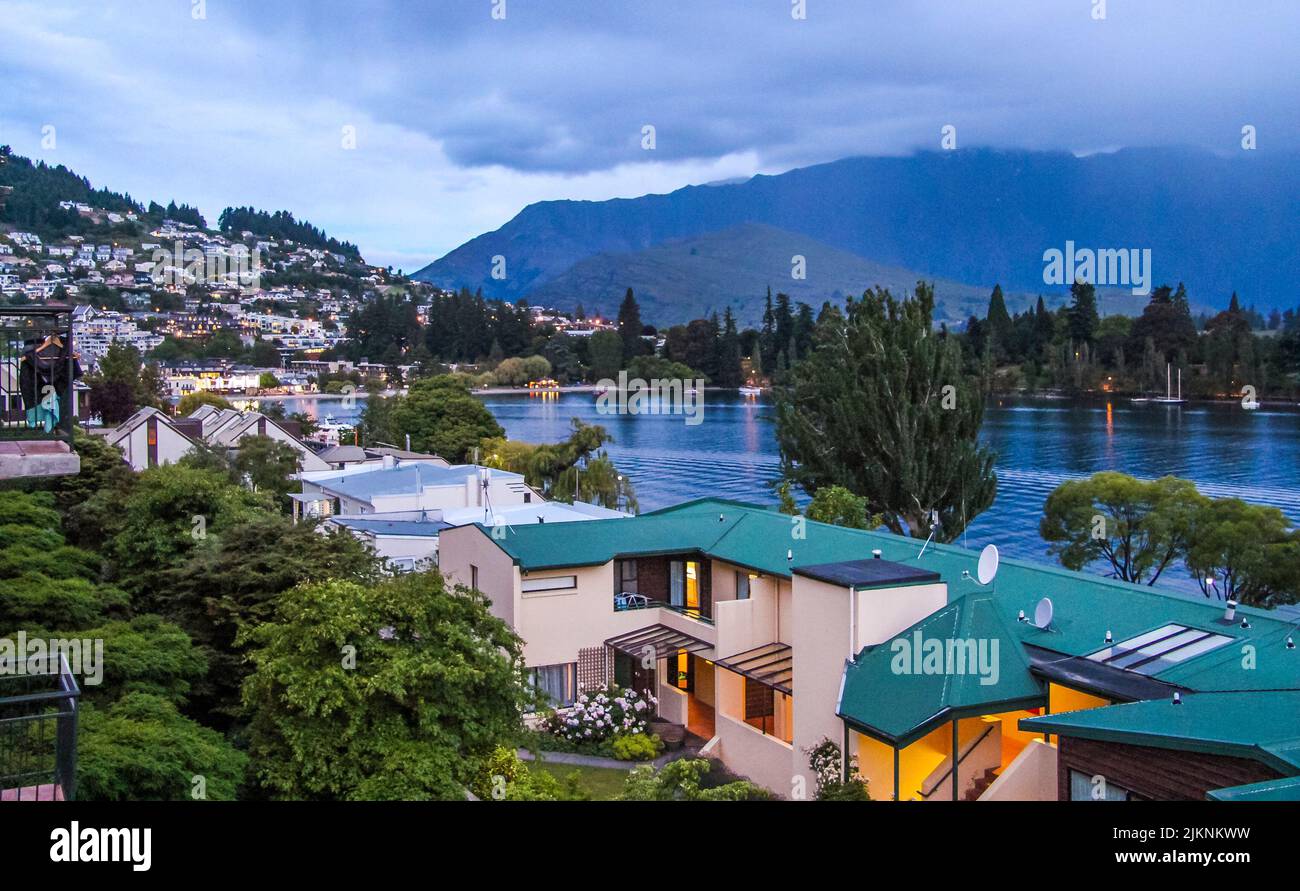 An aerial shot of Queenstown resort town with buildings in background ...
