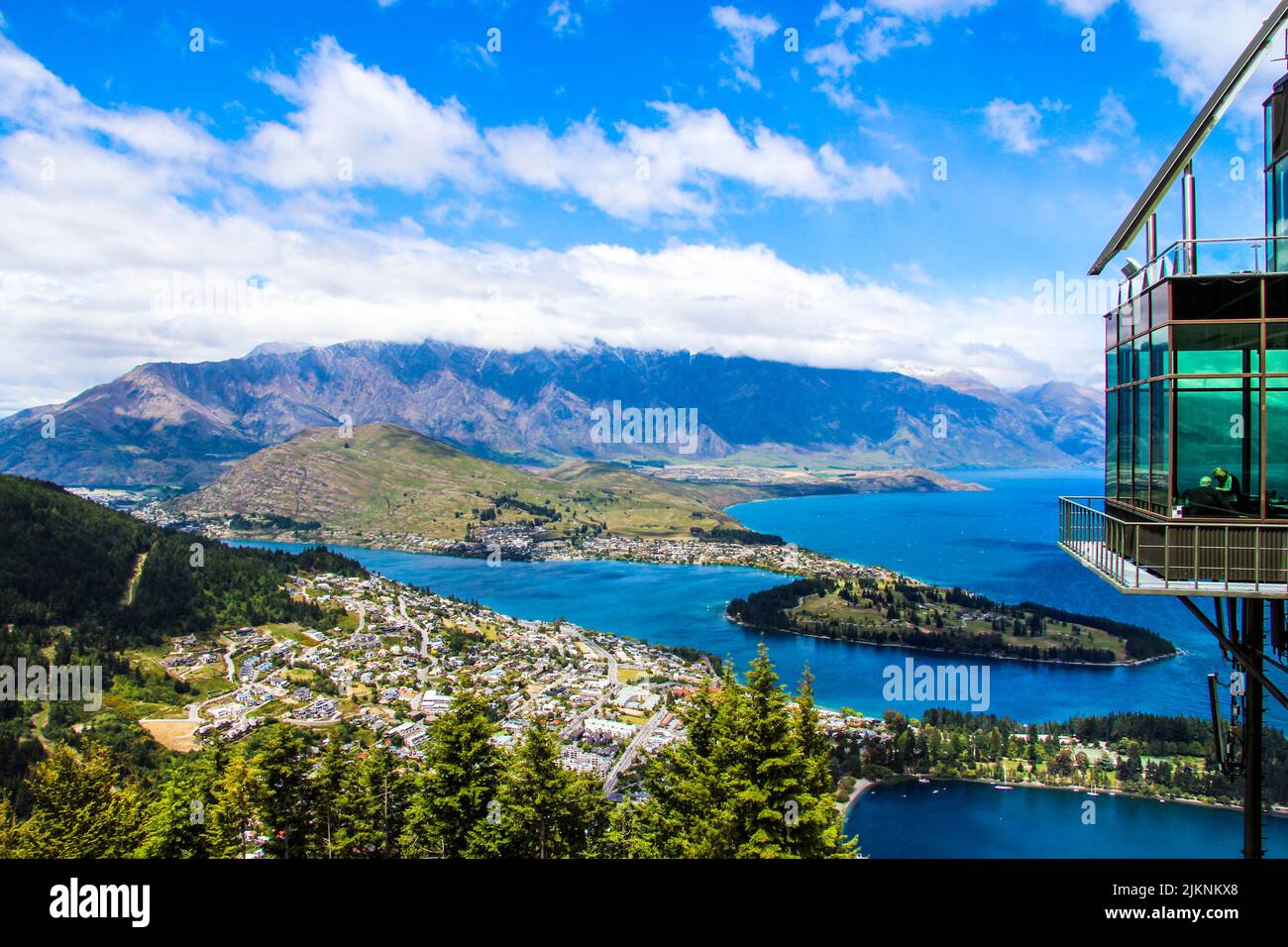 An aerial shot of Queenstown island in background of mountains in ...