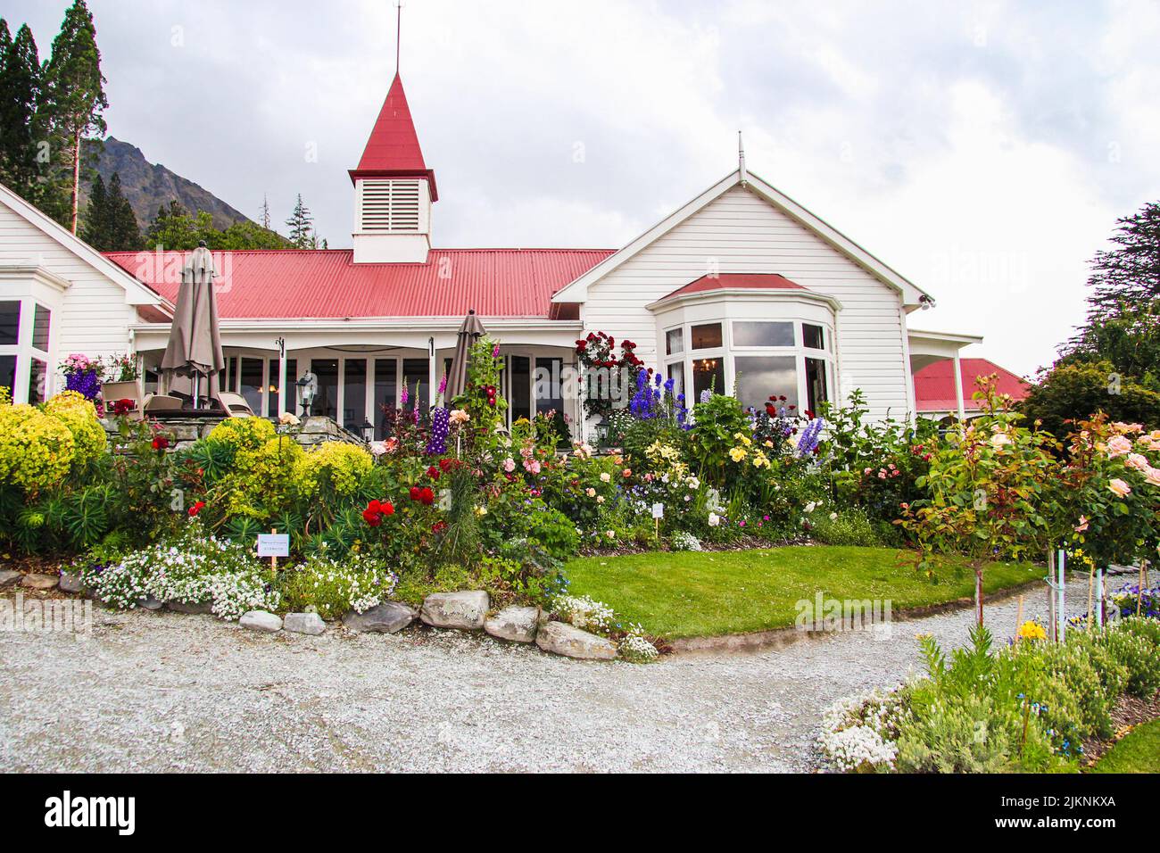 A large historic red building surrounded by colorful flowers in Walter ...