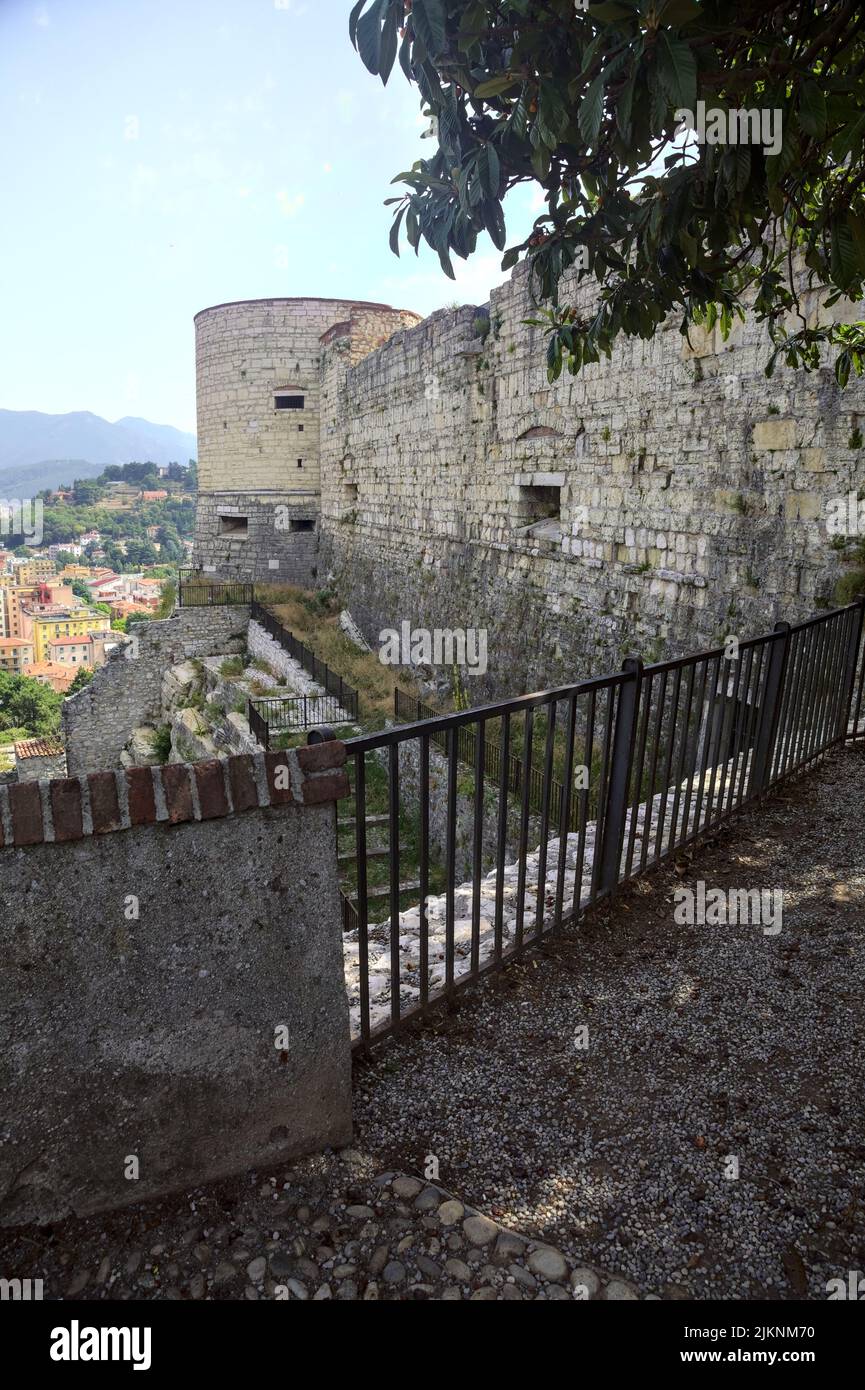 Balcony next to the walls of a castle on a cliff and a city below with ...