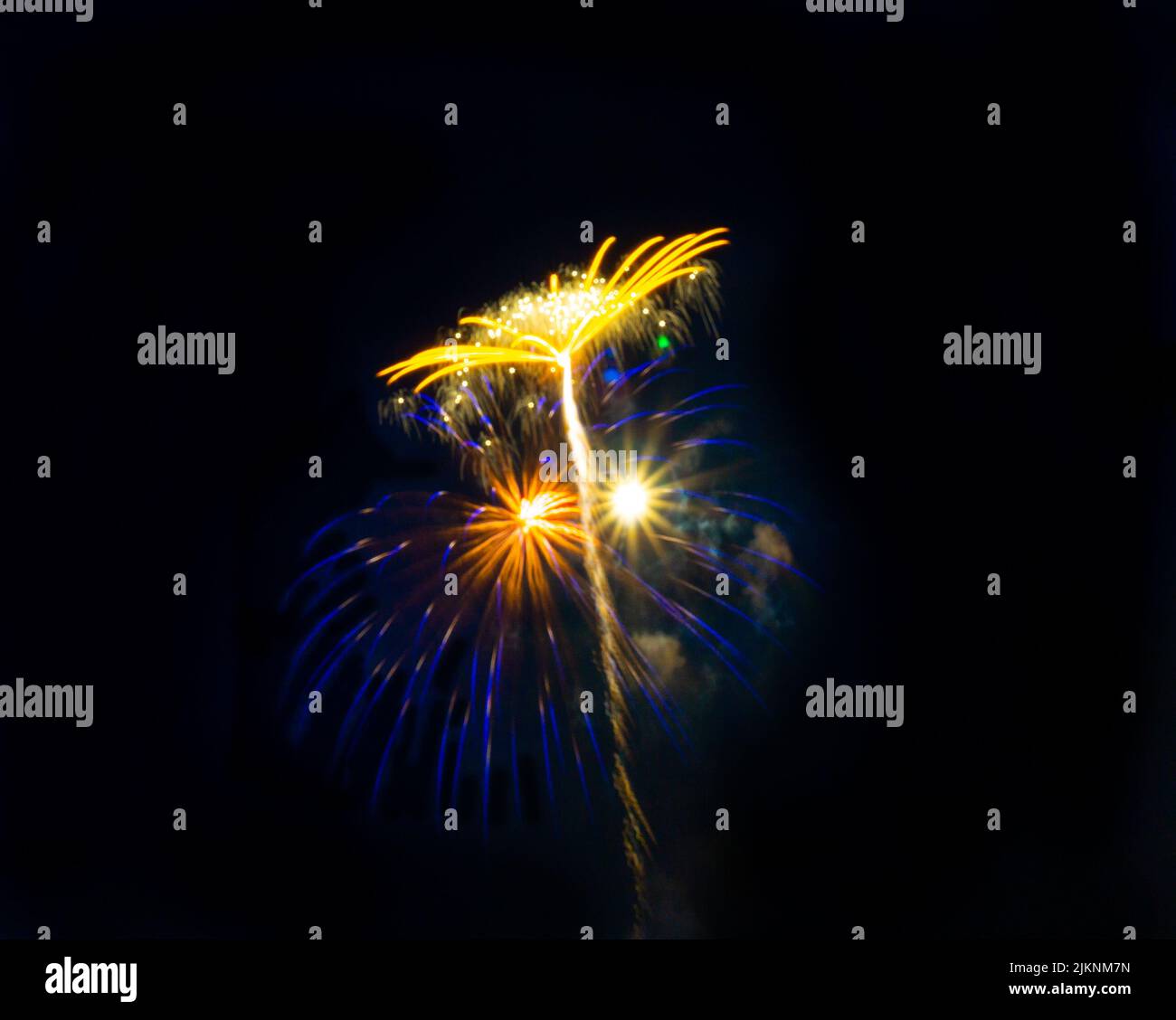 A view of fireworks in different colors glittering in the night sky ...