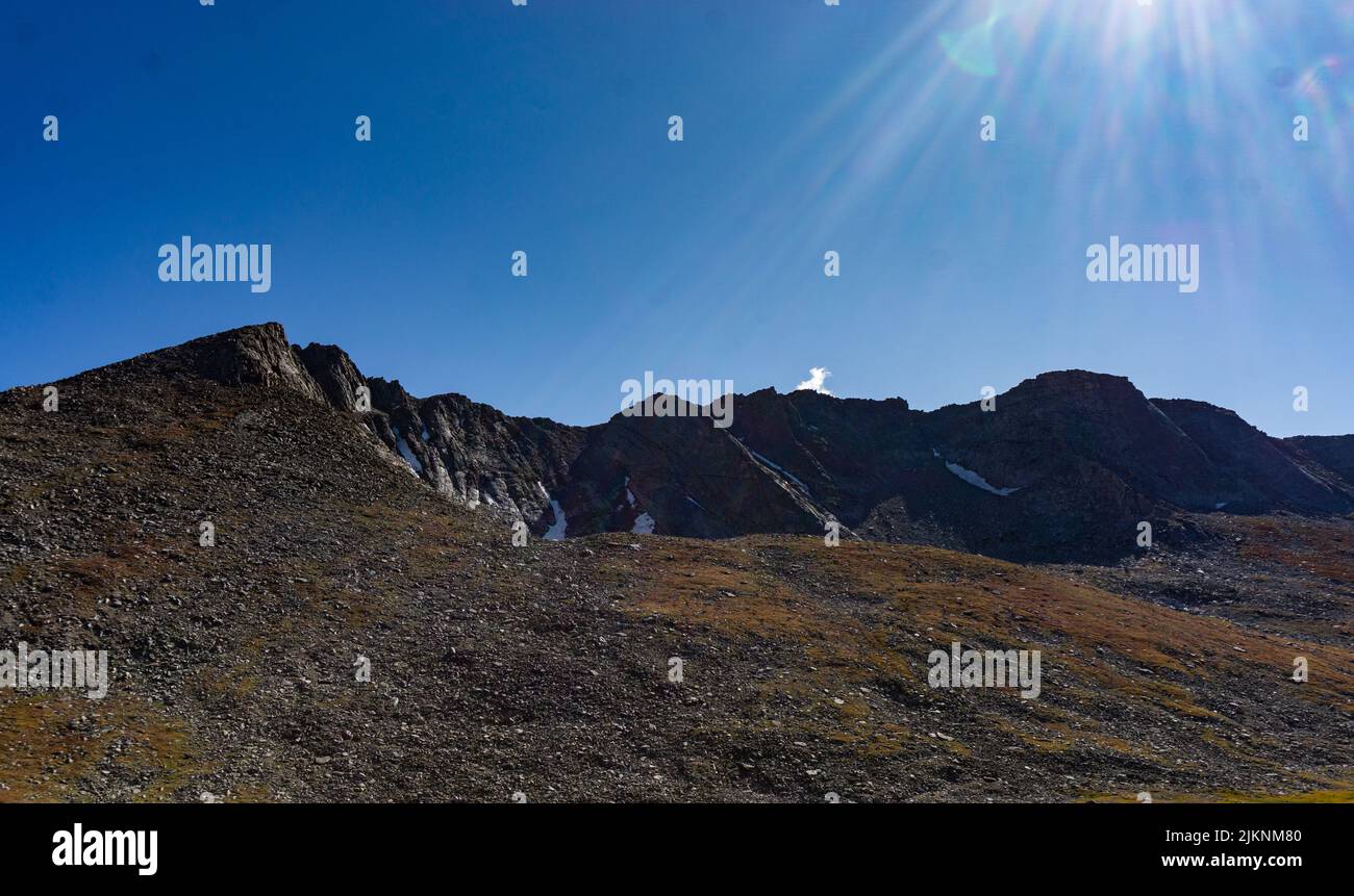 The blue sky and sun beams over mountain range in summer Stock Photo ...