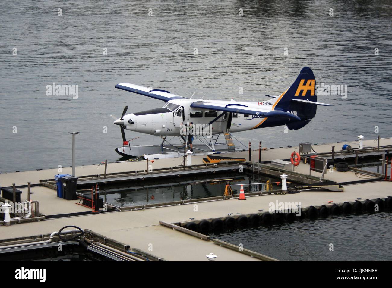 The De Havilland DHC-3 seaplane on the water surface near the dock ...