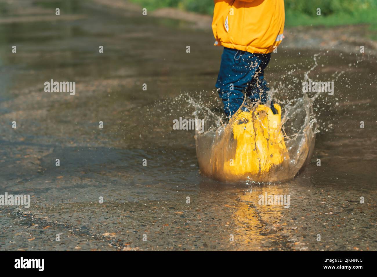 Kid jumping puddles hi-res stock photography and images - Alamy