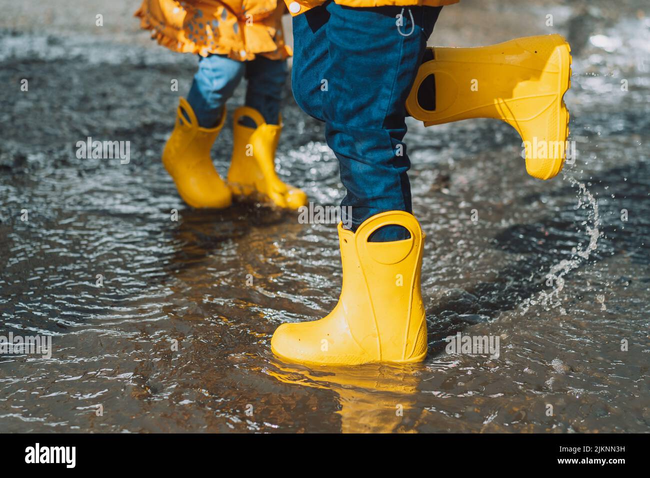 Children jumping in puddles hi-res stock photography and images - Alamy