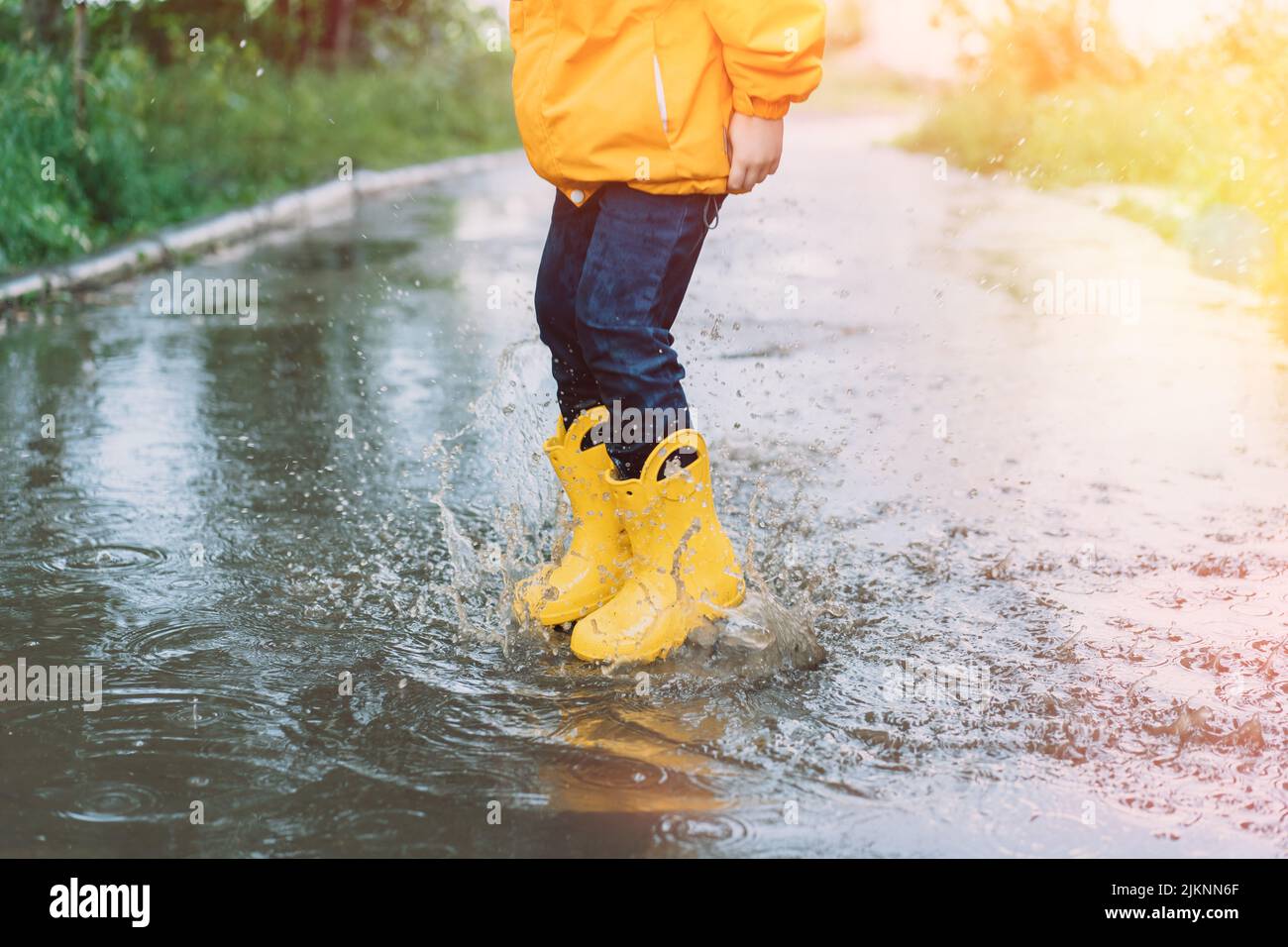 Toddler jumping puddles hi-res stock photography and images - Alamy