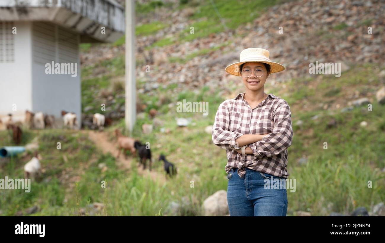 Female Woman worker posing on a Goats dairy farm out door ranch a farm ...