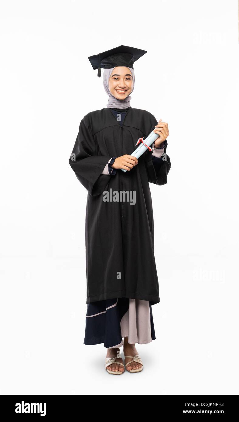 Beautiful asian woman wearing toga standing holding certificate roll ...