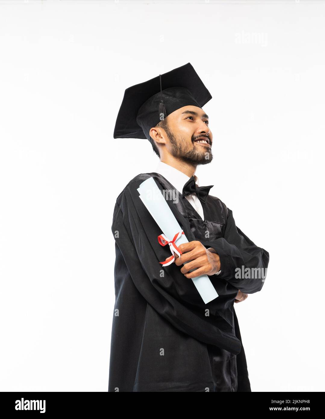 Confident asian male graduate wearing toga and holding certificate ...