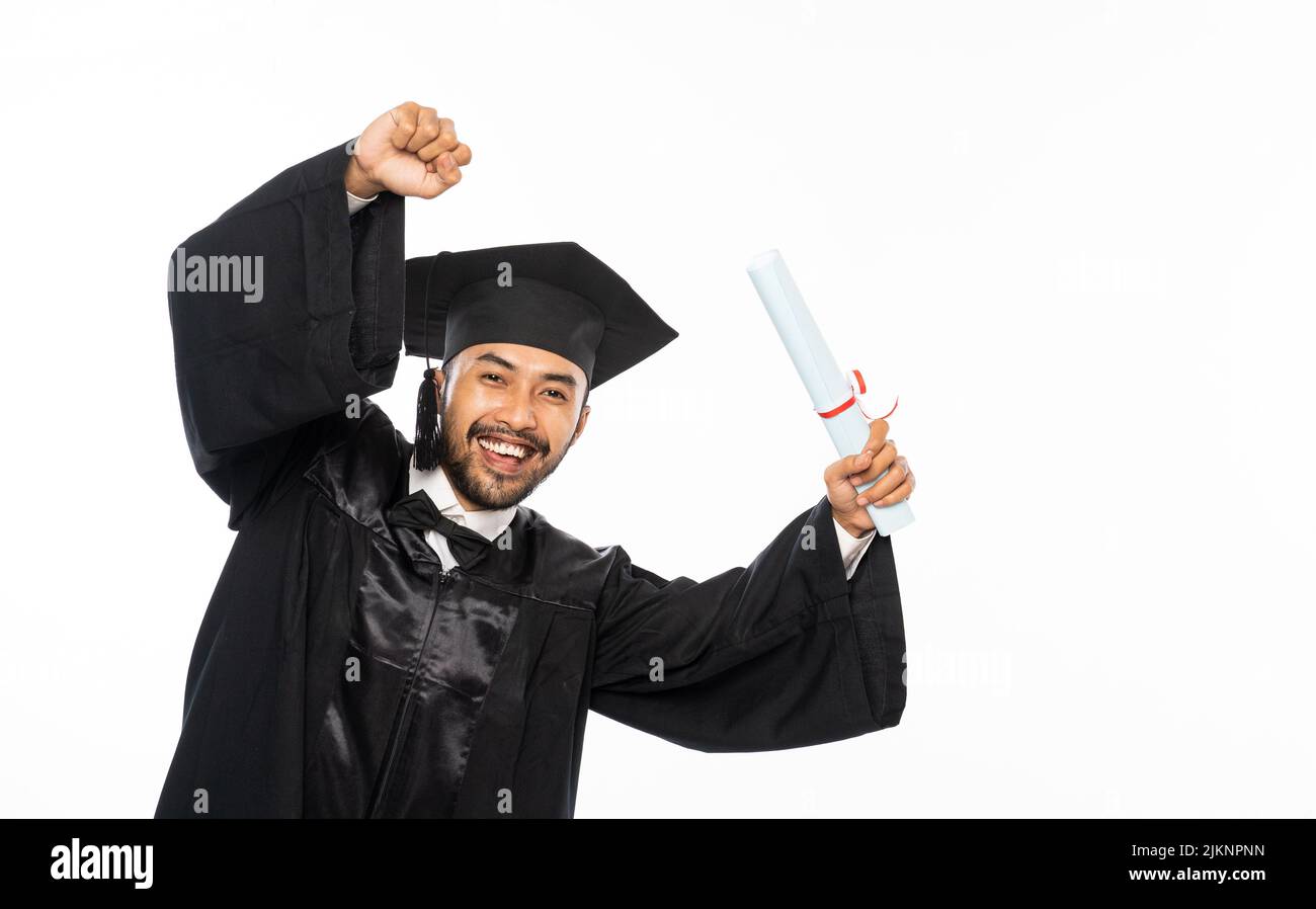 Excited male college graduate student holding roll certificate standing ...