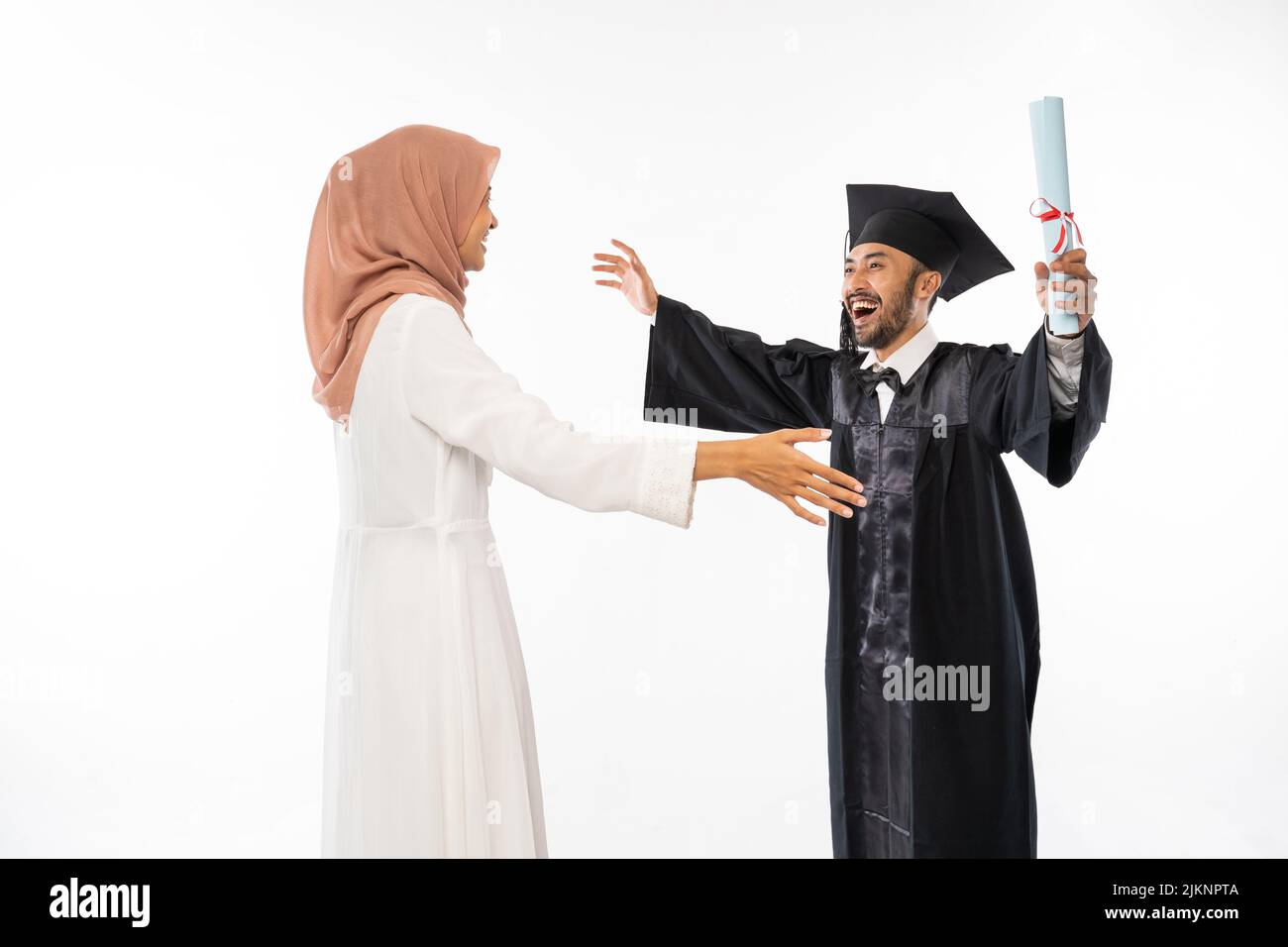 Happy graduate male student wearing toga will hug his lover Stock Photo ...