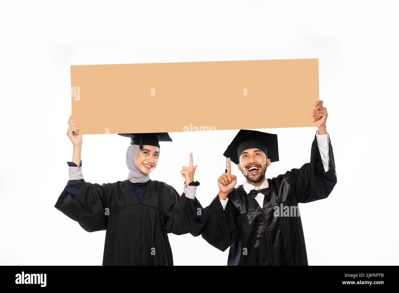 Asian couple of graduate student wearing toga holding cardboard Stock ...