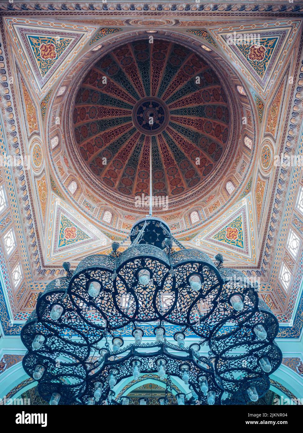 A beautiful view of a huge chandelier hanging in an antique style ...