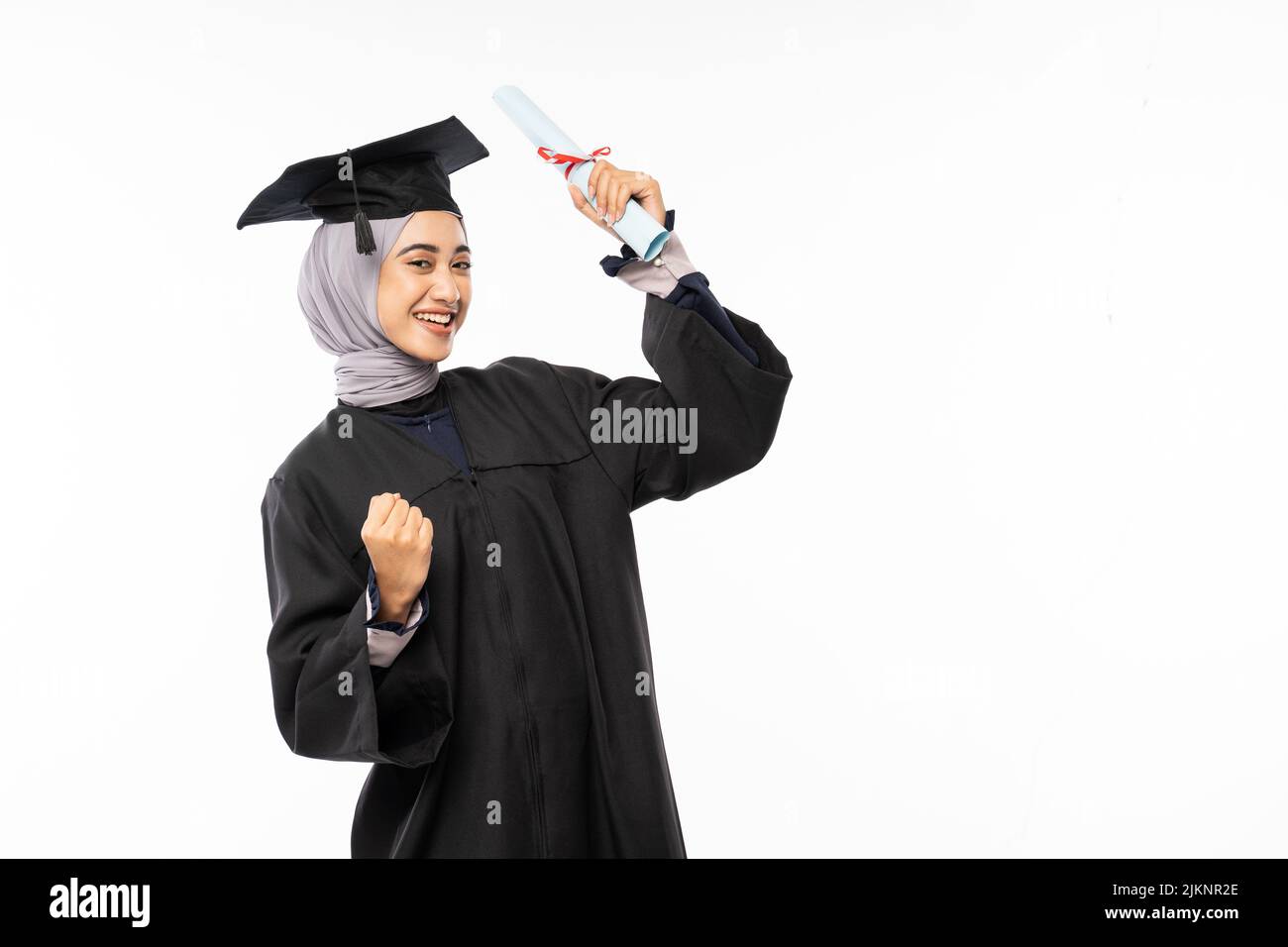 Female bachelor graduate wearing toga with hand clenched Stock Photo ...