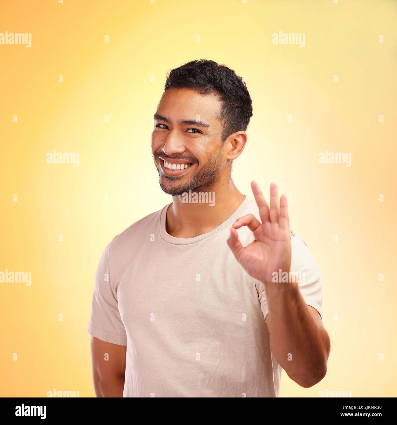 I think youre doing great. a young man showing the ok sign while ...
