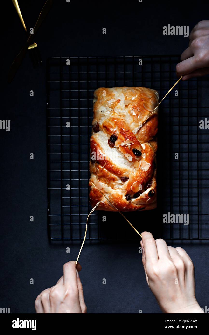 A top view of bread with raisins and cinnamon on a baking net with ...