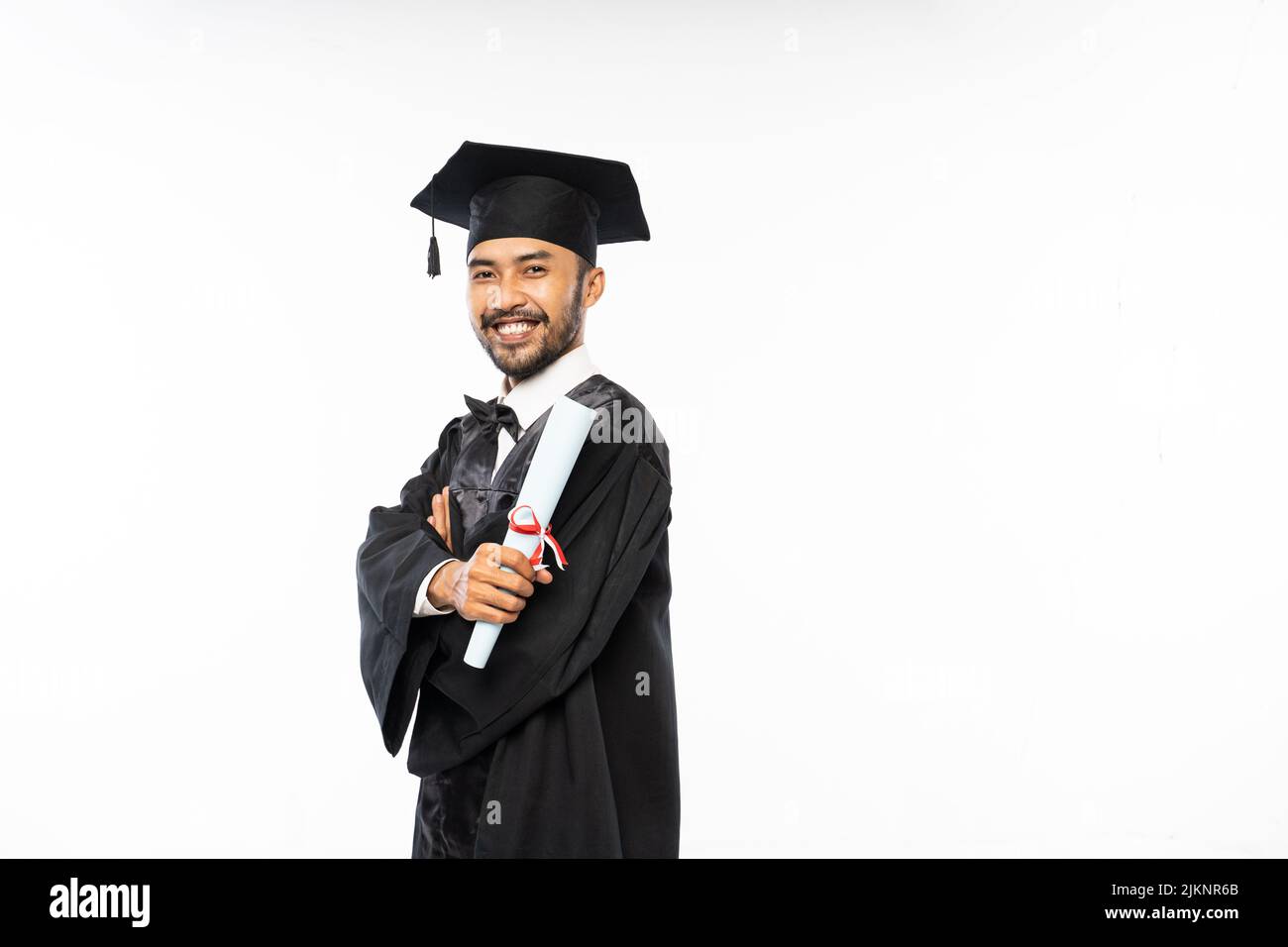 Bearded adult man wearing toga smiling holding certificate paper ...