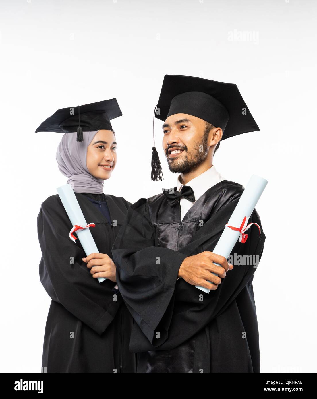 Couple of graduate students holding certificates standing opposite each ...