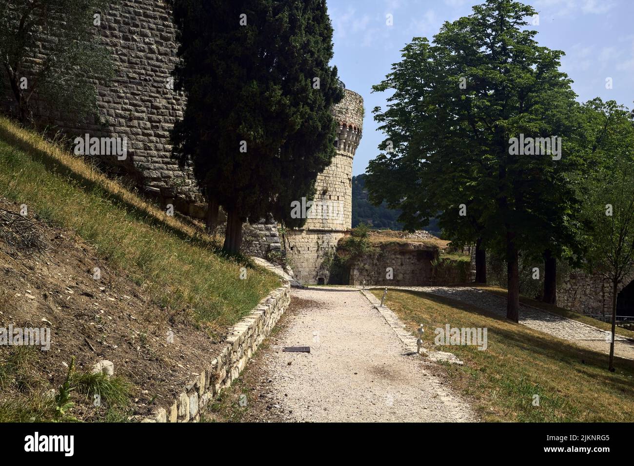 Dirt path next to the walls of a castle on a sunny day Stock Photo - Alamy