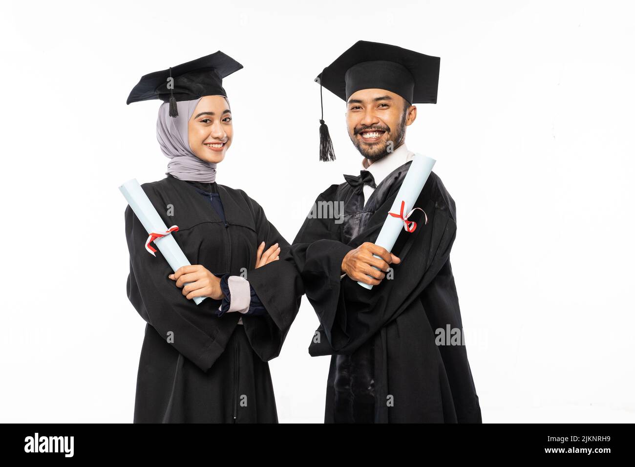 Two asian graduate students with crossed arms while holding certificate ...