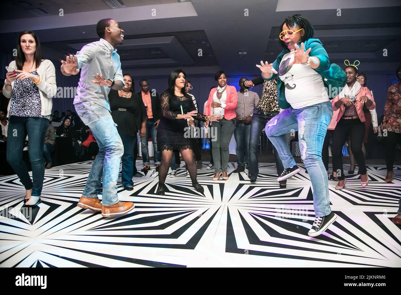 A group of diverse people dancing at a party in Johannesburg, South ...