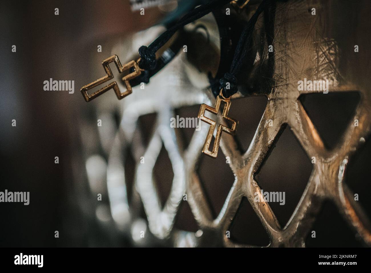The hanging golden crosses with black strings Stock Photo - Alamy