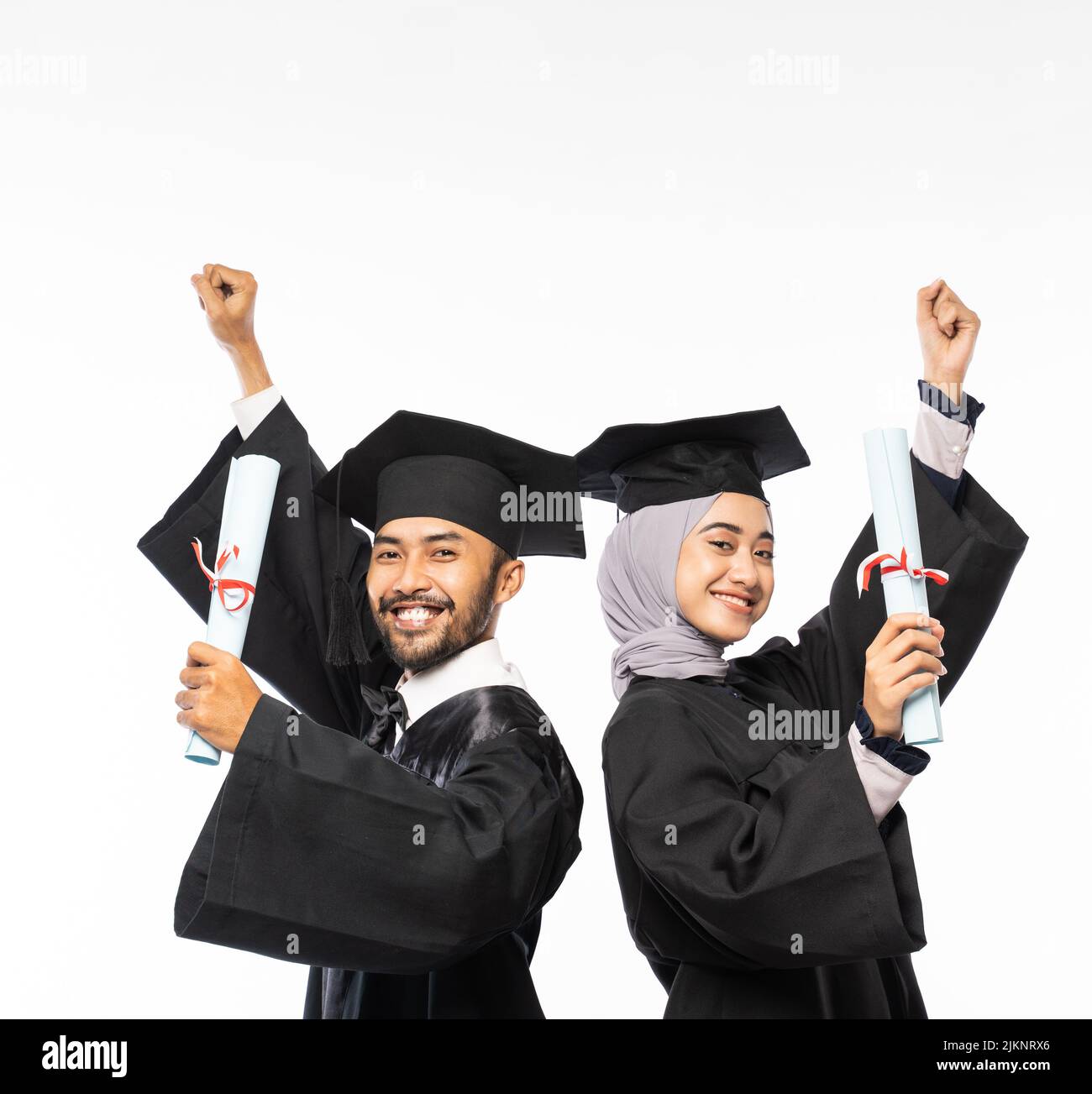 Excited graduate boy and girl in toga holding certificates Stock Photo ...