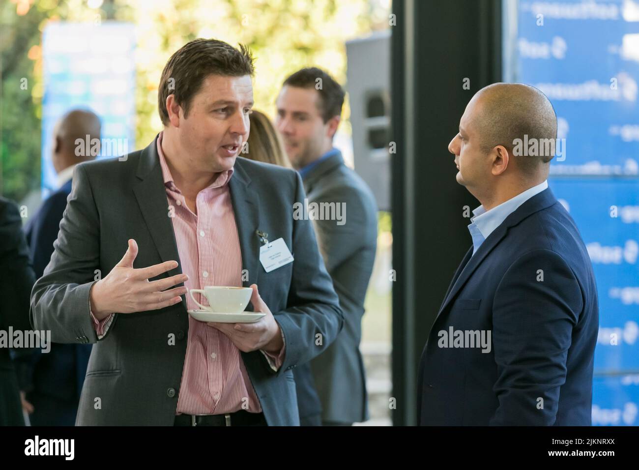 A group of delegates networking at a business conference in ...