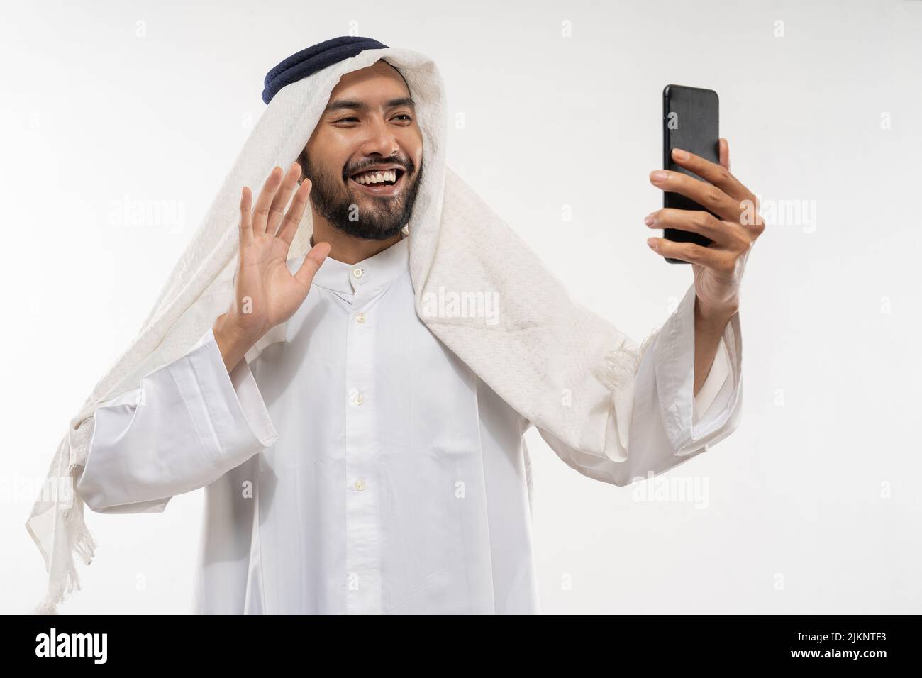 man in a turban using a mobile phone video conference and calling Stock ...