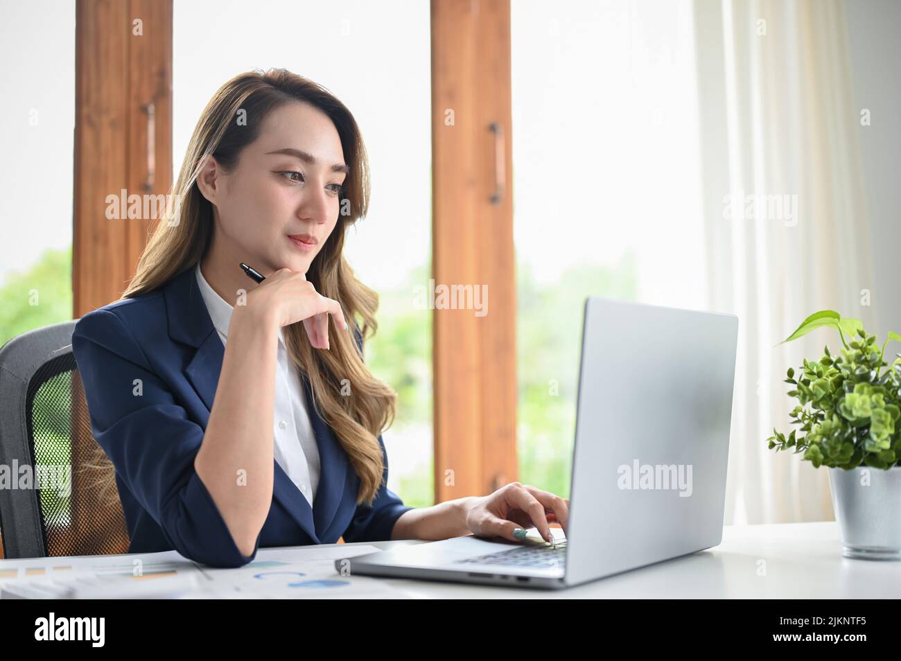 Charming and professional young Asian businesswoman or female executive ...