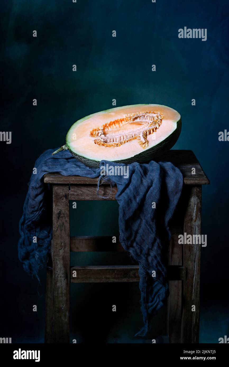 A vertical closeup of the cut melon on the chair. Still life Stock ...