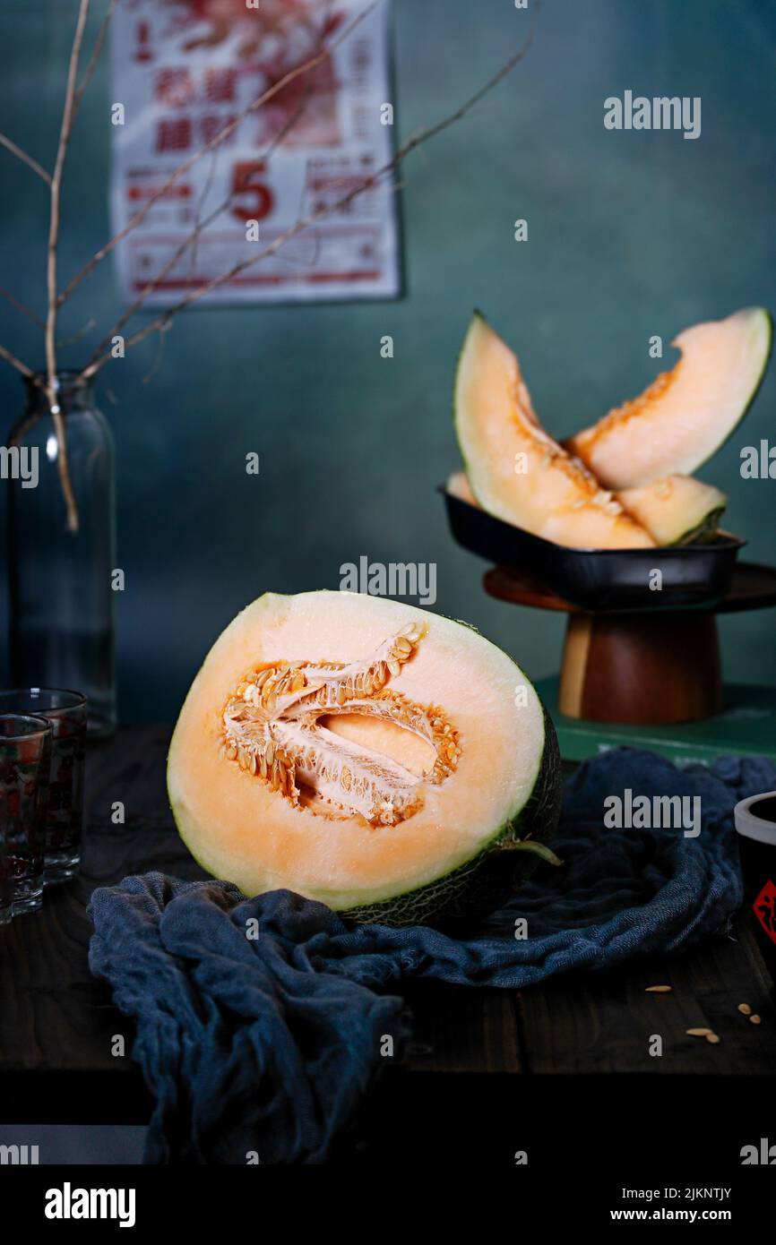 A vertical closeup of the cut melon on the table. Still life Stock ...