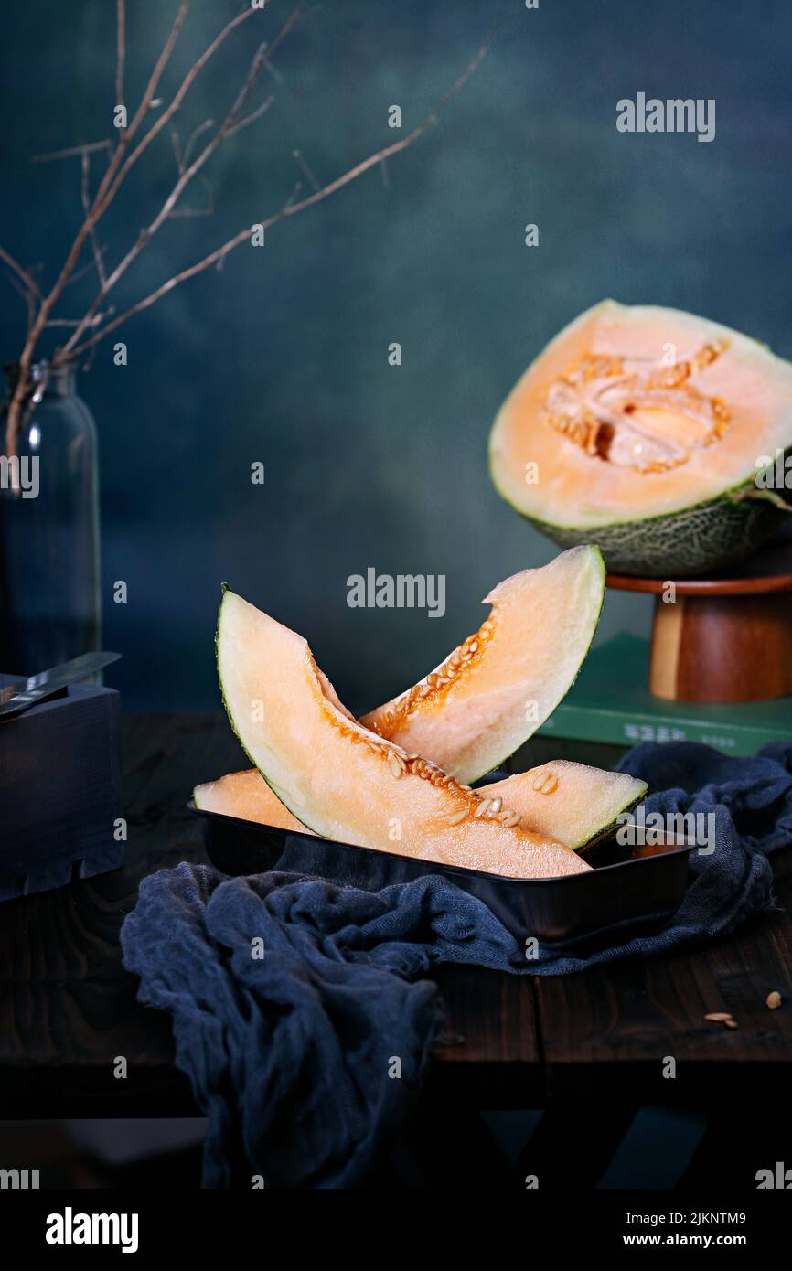 A vertical closeup of the cut melon on the table. Still life Stock ...