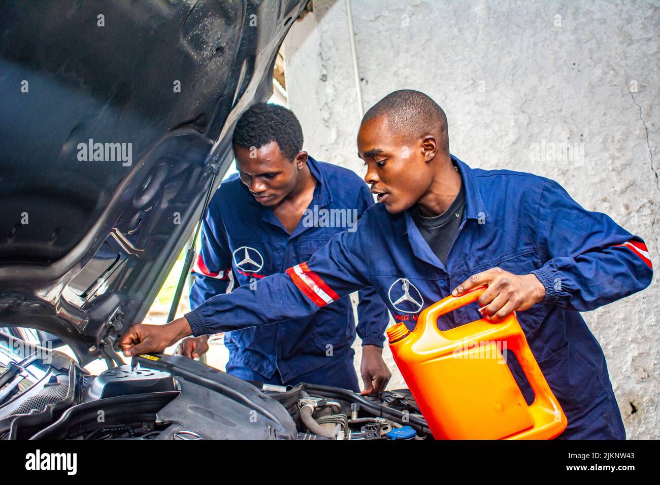 The auto mechanics working on the car system in Zimbabwe Stock Photo ...