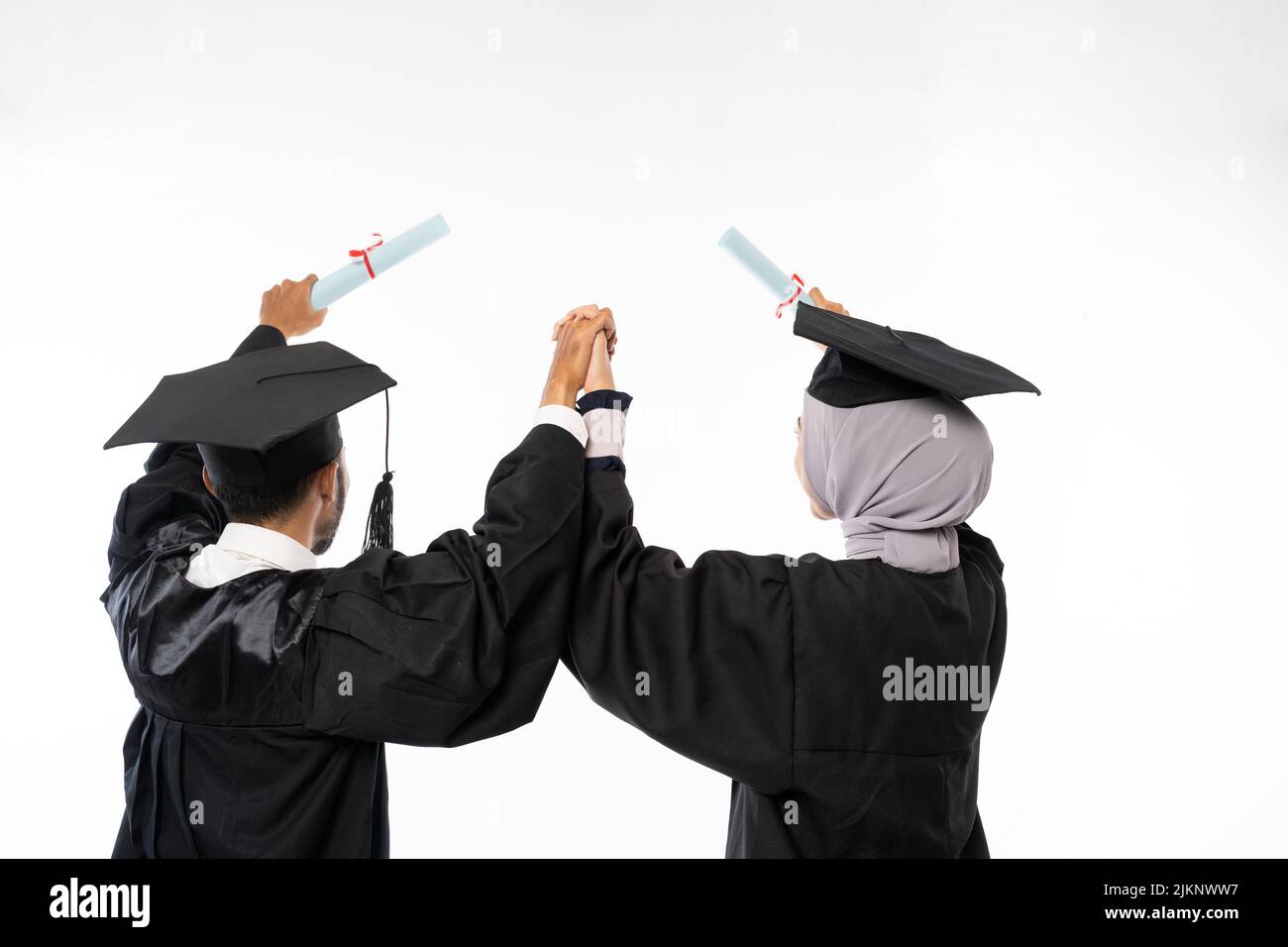 Two graduate students holding hands and holding up certificate Stock ...