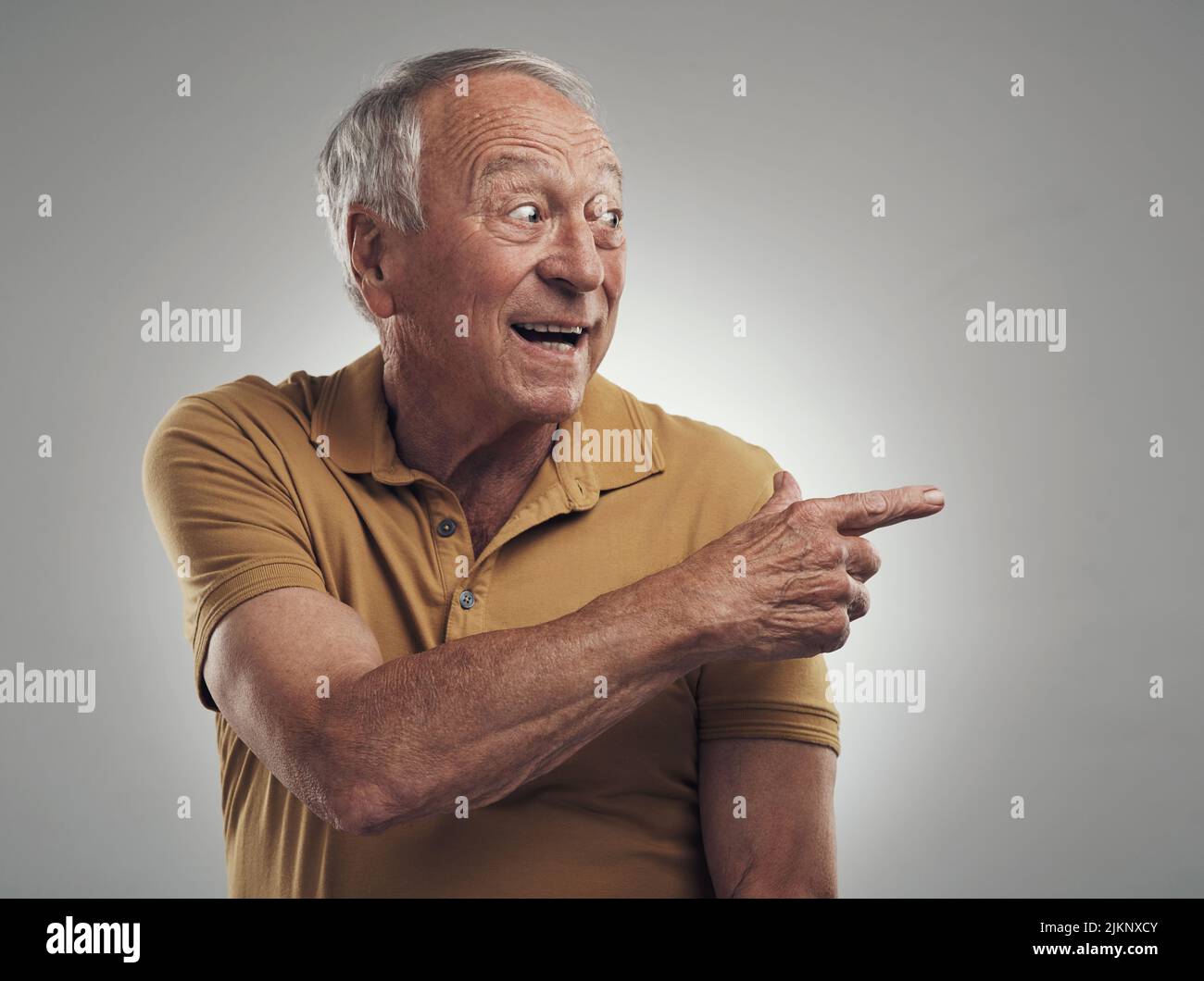 He went that way... Studio shot of an elderly man pointing in at ...