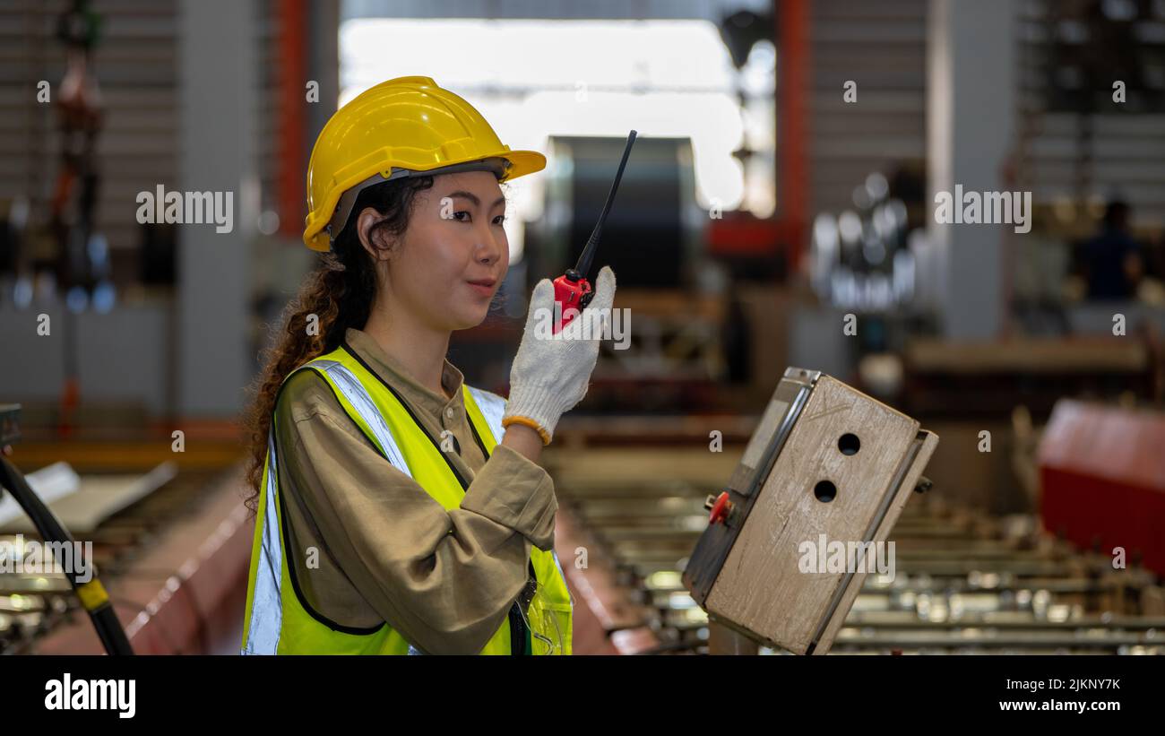 Woman use Walkie Talkie in Manufacturing Factory Stock Photo - Alamy