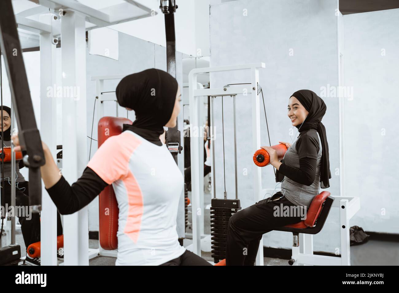 woman using chest press machine during fitness at the gym Stock Photo ...