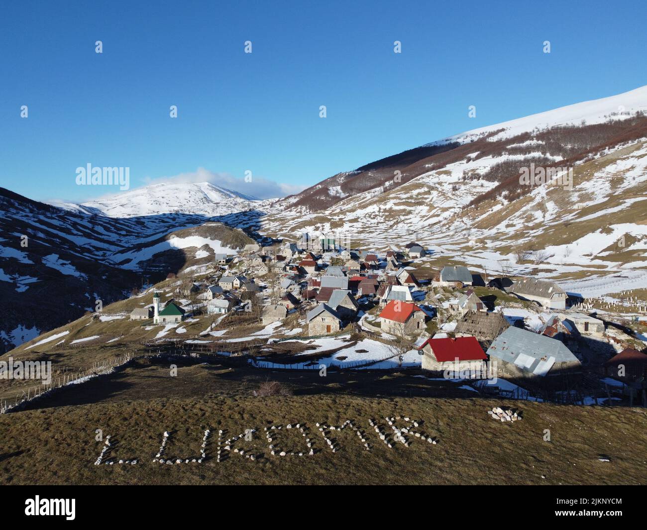 An aerial view of the village Lukomir surrounded with snow-covered ...