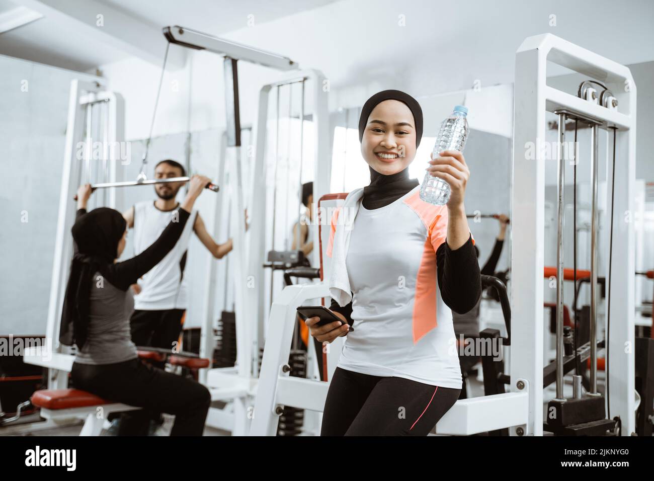 asian woman working out and drinking water bottle Stock Photo - Alamy